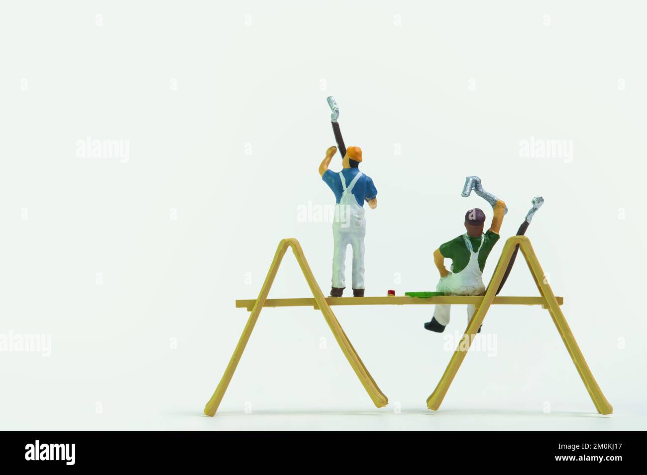 The miniature figures of construction workers painting the walls on a ...