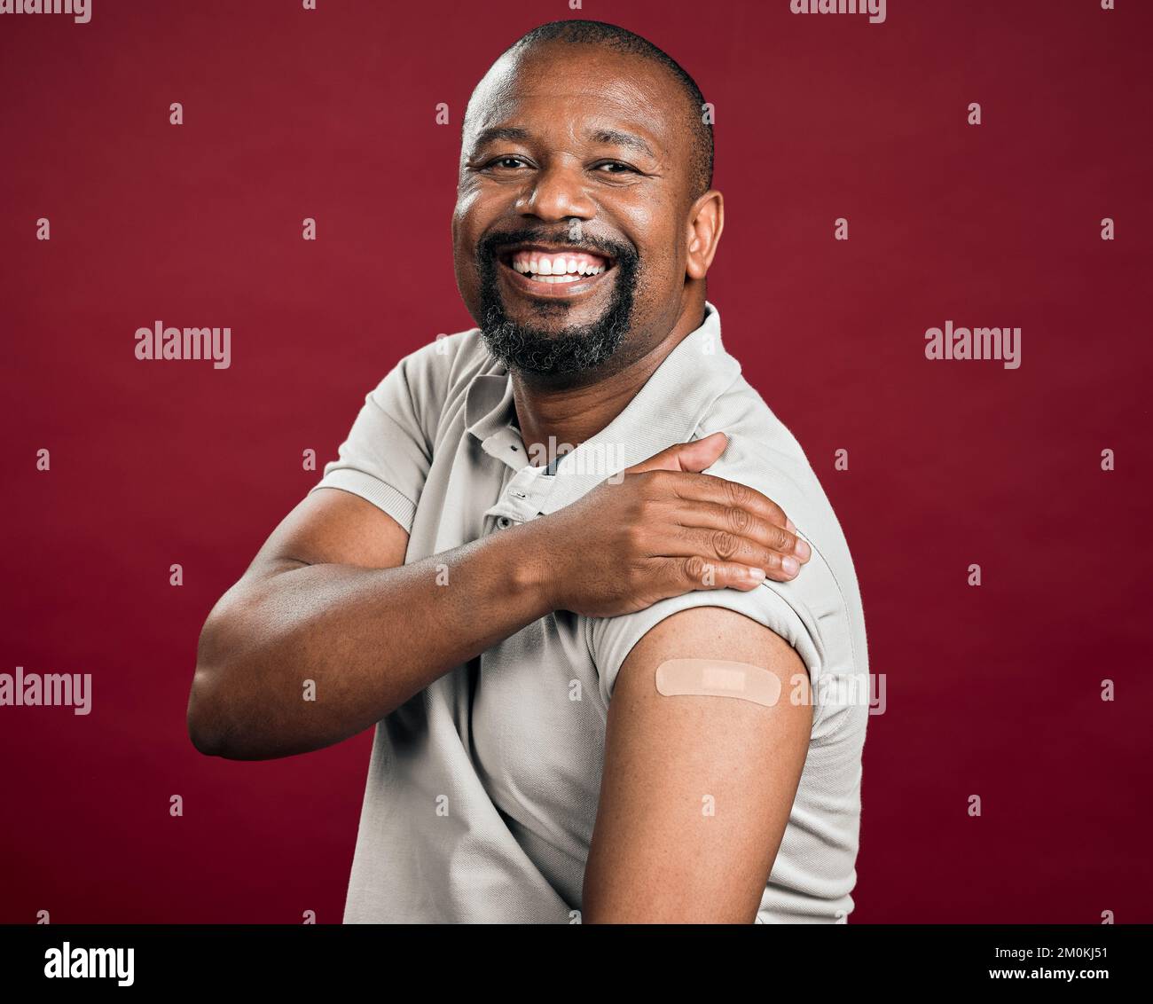 African american covid vaccinated man showing arm plaster and smiling ...