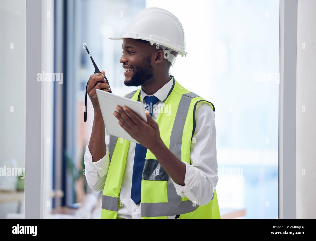 Engineer, walkie talkie and black man construction worker, building ...