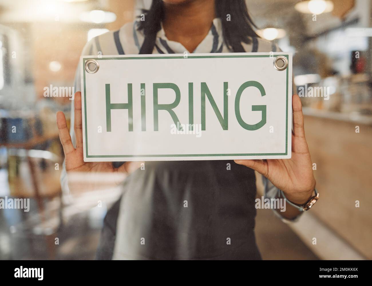 Hands of business owner holding hiring sign. Businesswoman hanging ...