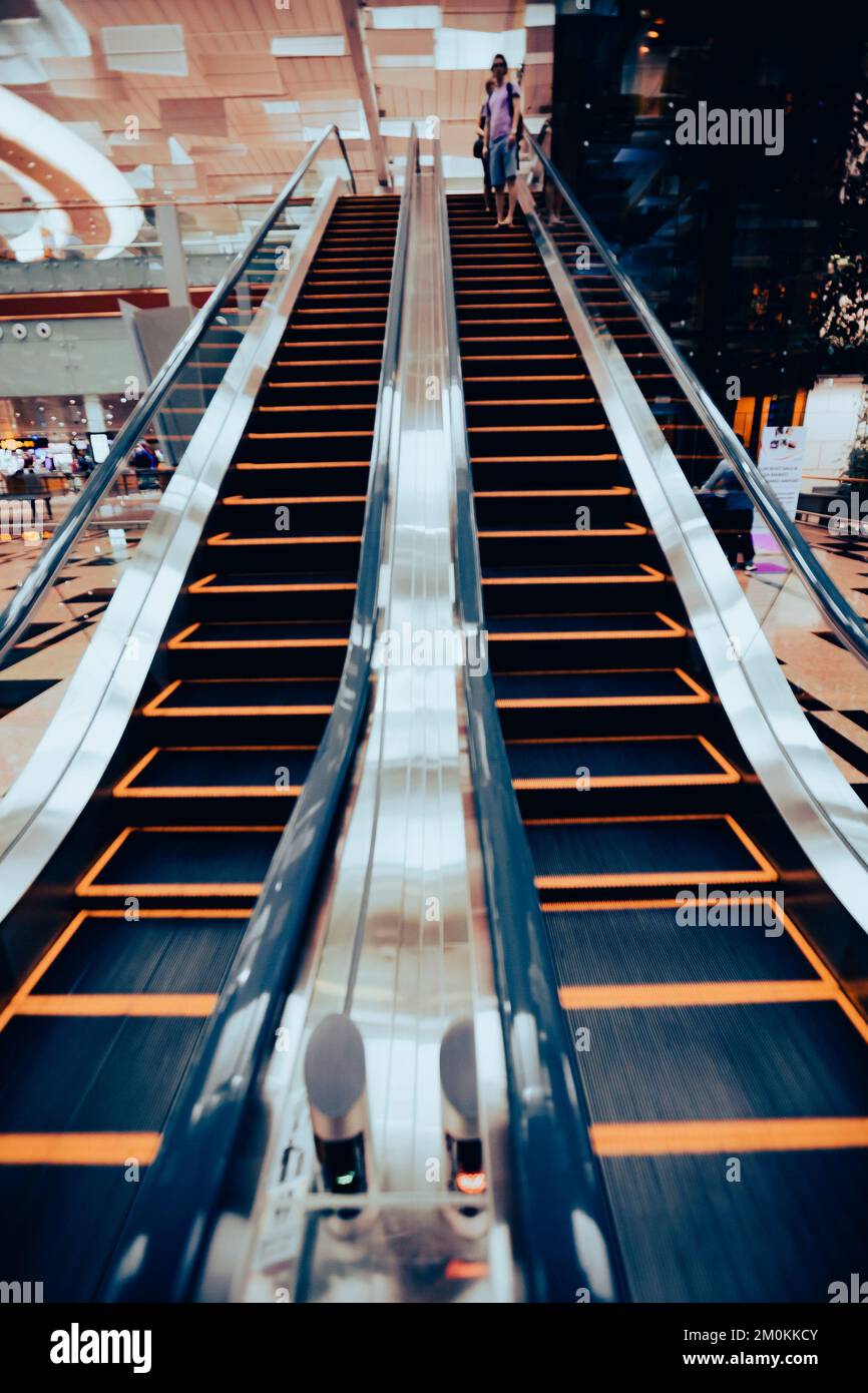 Colorful escalators inside an airport or mall Stock Photo - Alamy