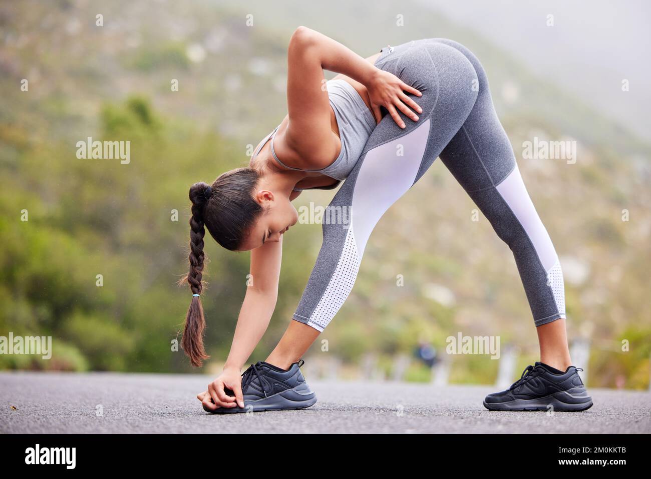 Woman touching foot bending hi-res stock photography and images - Alamy