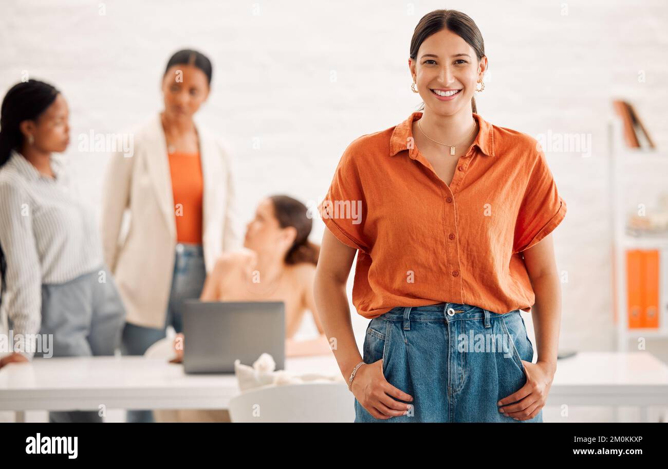 Portrait of a happy mixed race businesswoman standing in an office at ...