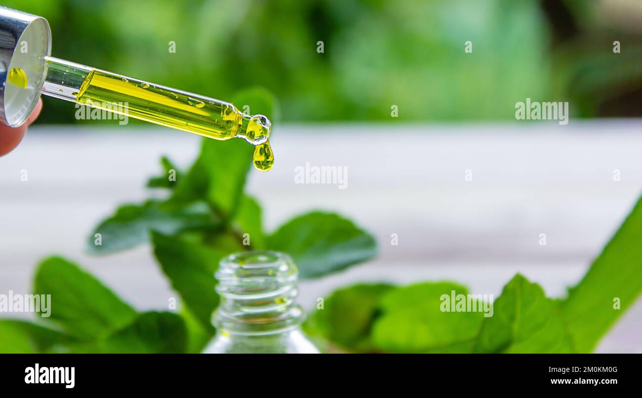 The mint extract in a small jar. Selective focus Stock Photo - Alamy