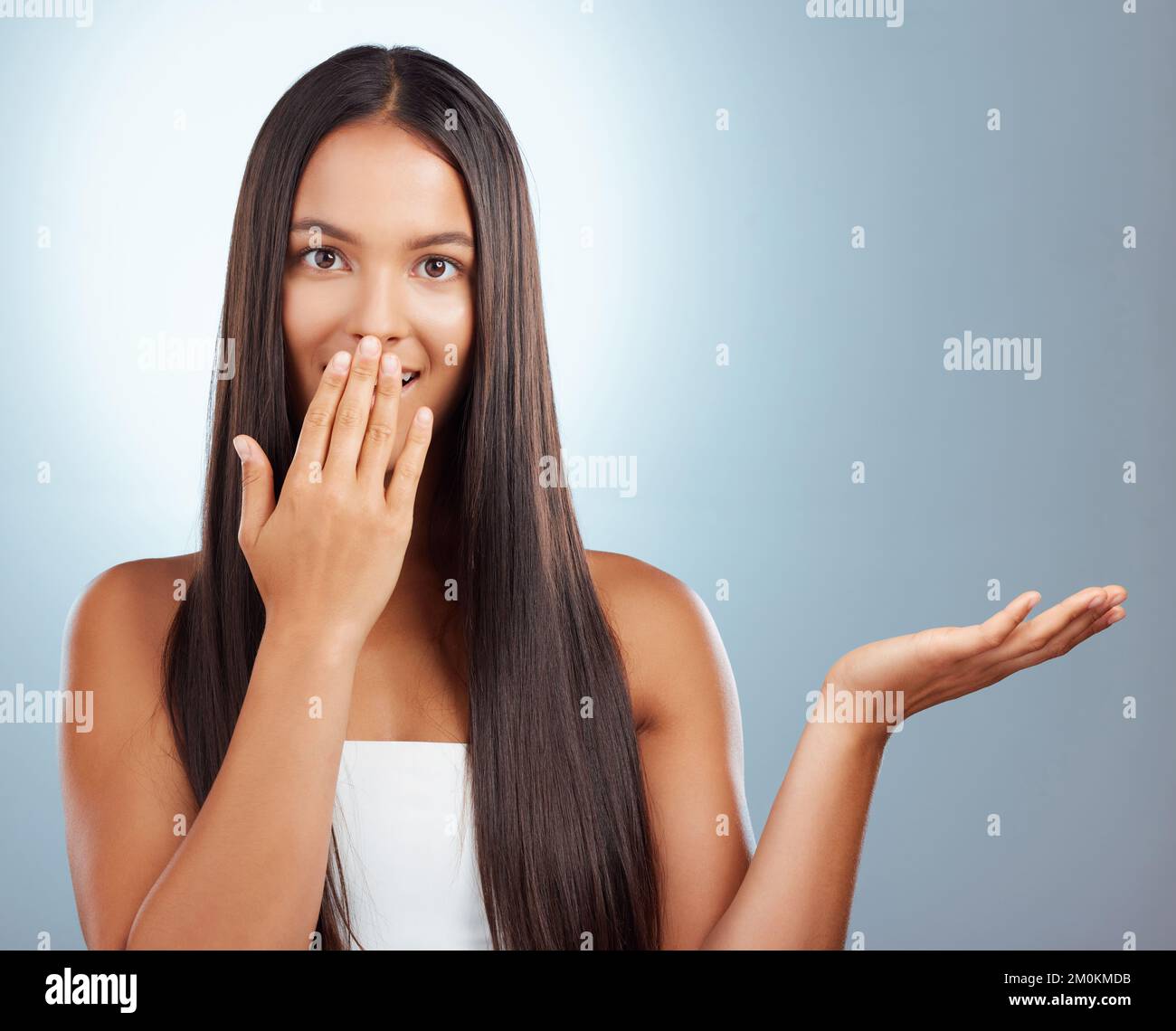 Portrait of a young mixed race beautiful woman standing looking shocked ...
