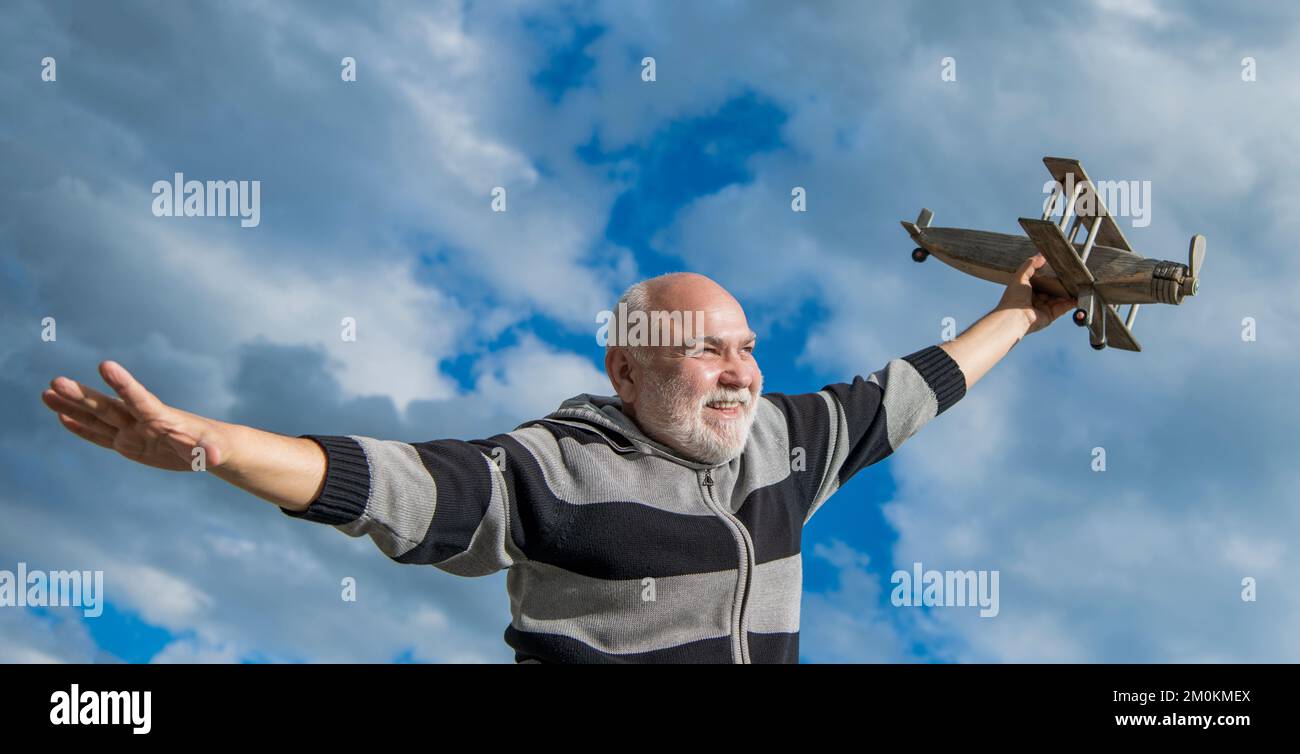 happy retirement. caucasian granddad with toy. retired old man outdoor ...