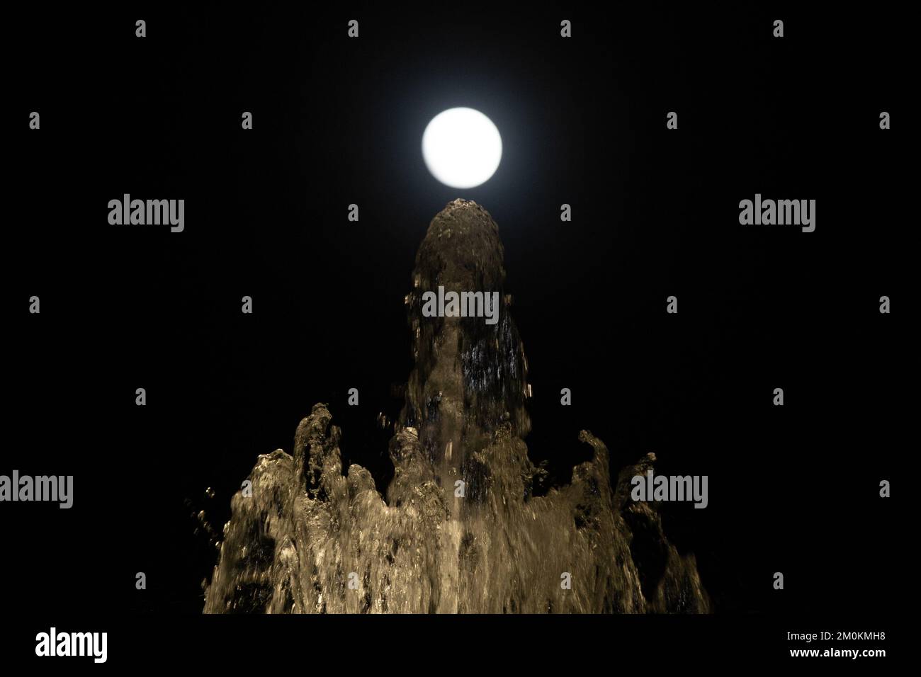 View of the moon with water from a fountain in St. Peter's Square ...