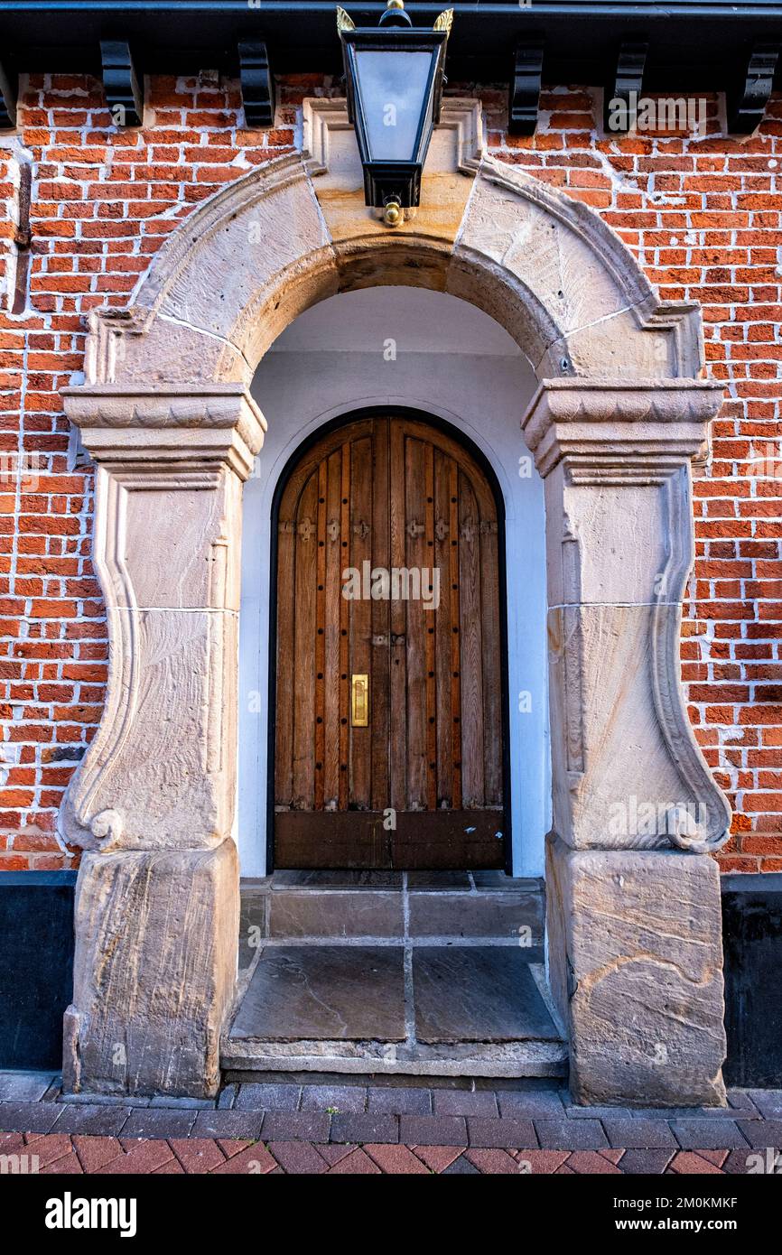 Old wooden gothic door with outside light Stock Photo - Alamy