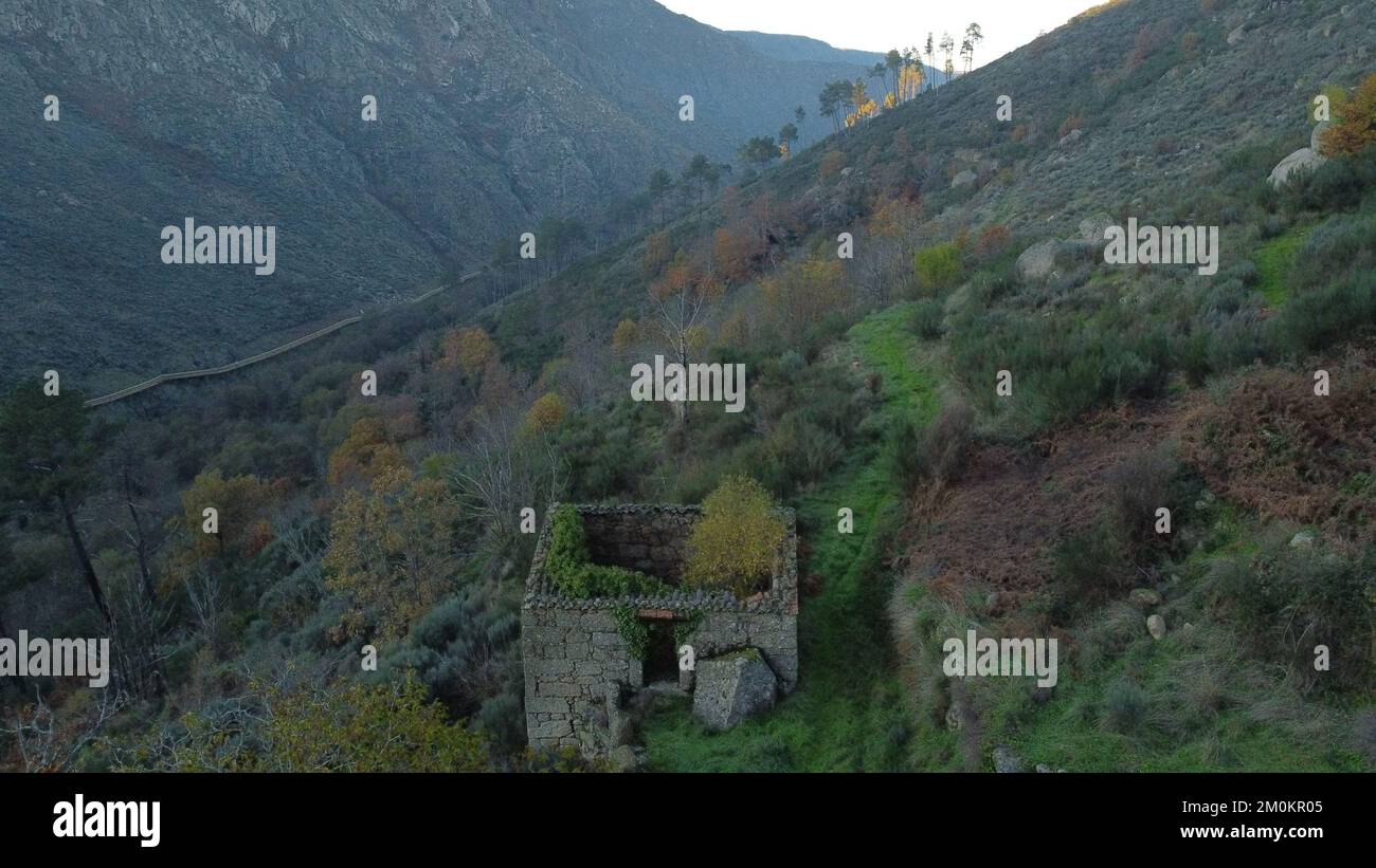An aerial view of an incomplete square construction on a hill in autumn ...