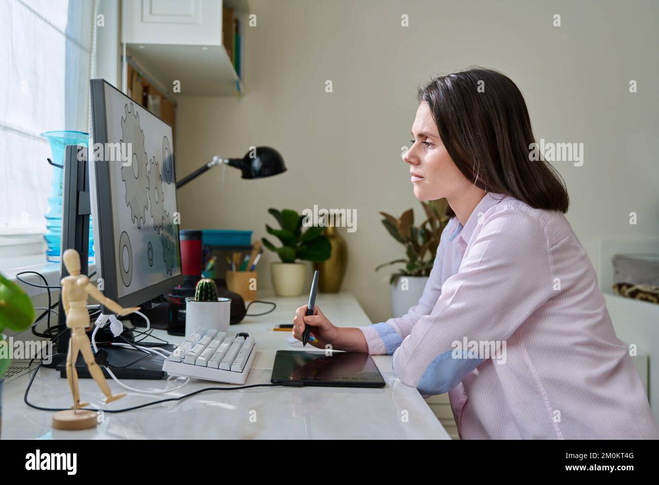 Woman designer artist working in home, using graphic tablet computer ...