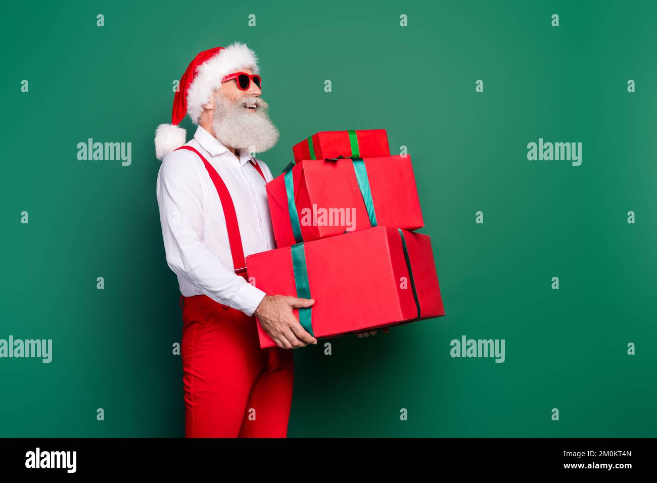 Photo of cute dreamy man dressed xmas costume holding gifts stack ...