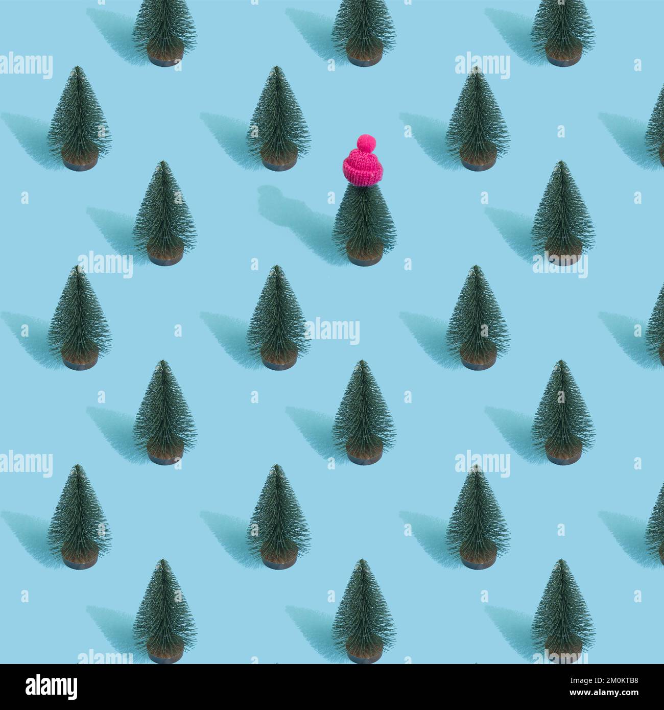 New Year pattern made with Christmas trees on bright light blue ...