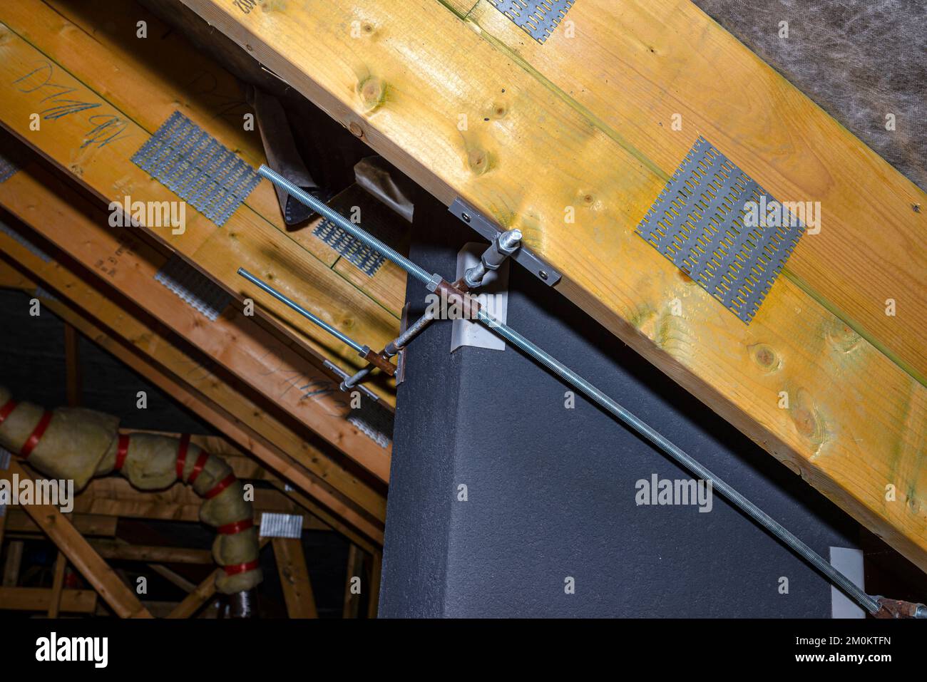 Steel fixing of the ceramic chimney to the trusses inside the attic ...