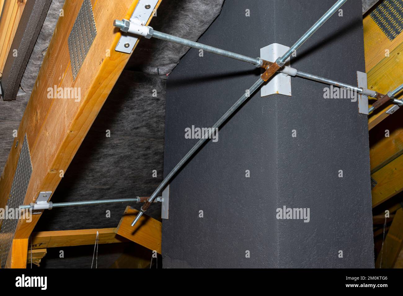 Steel fixing of the ceramic chimney to the trusses inside the attic ...
