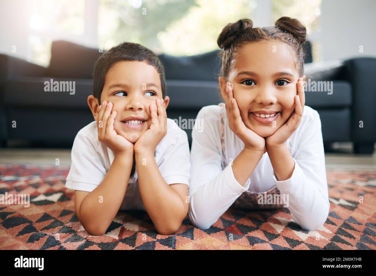 Portrait Of Two Mixed Race Young Siblings Lying On The Floor Together