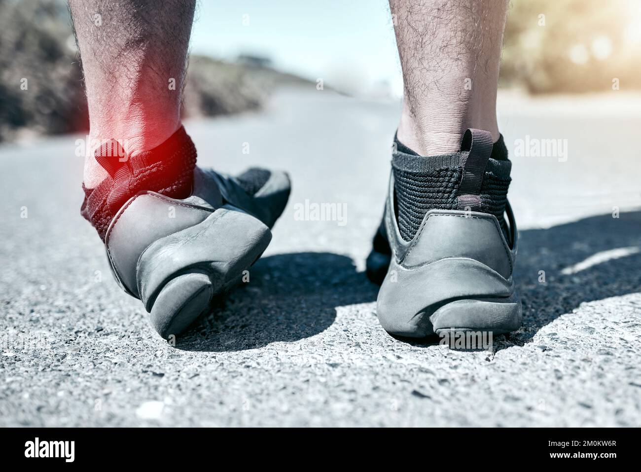 Closeup fit mixed race man holding his ankle in pain while exercising ...