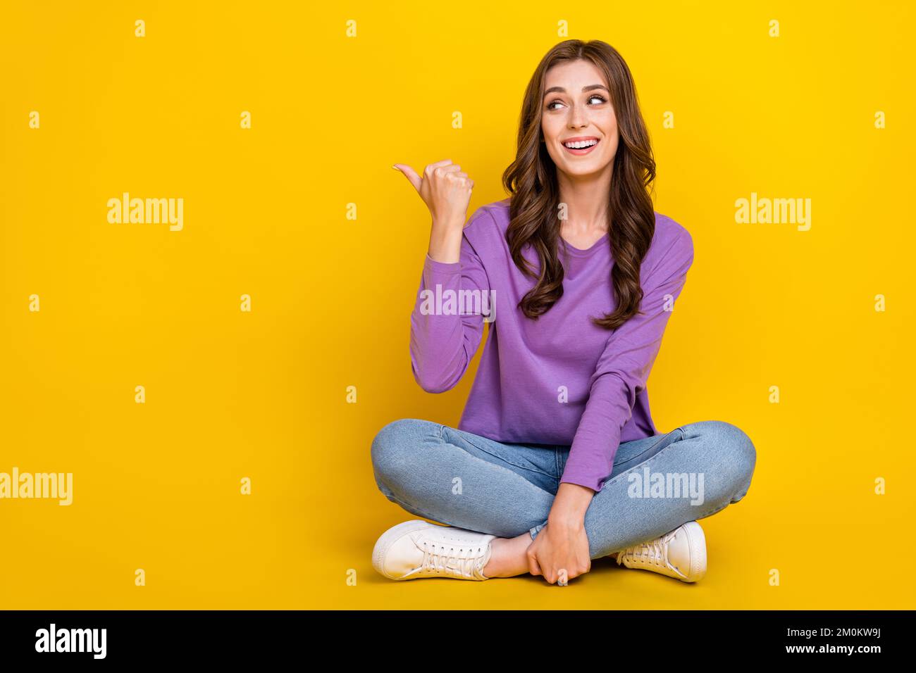 Full length portrait of cheerful nice person sit floor look direct ...