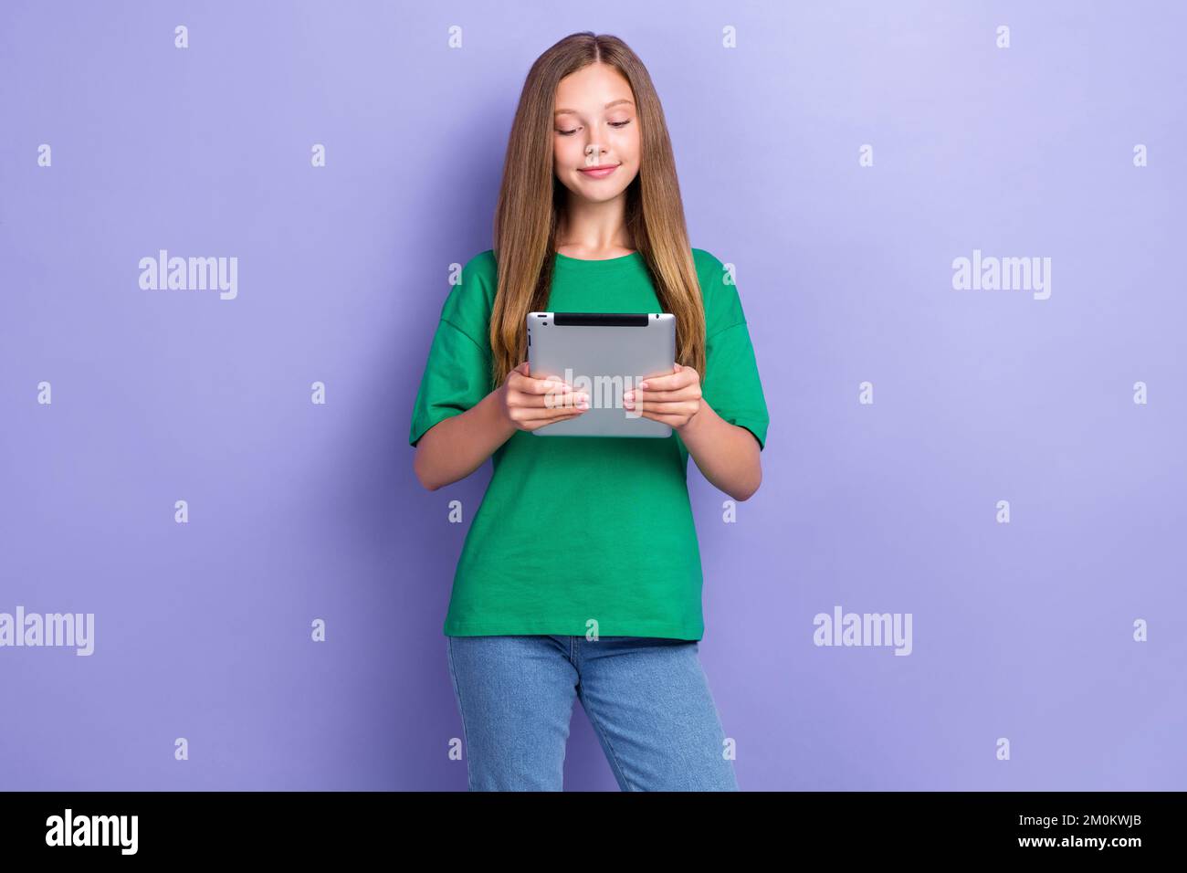 Photo of pretty concentrated lady schoolkid hold modern device gadget ...