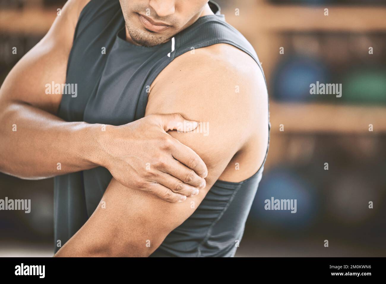 Fit man experiencing arm cramp. Bodybuilder with shoulder pain in the ...