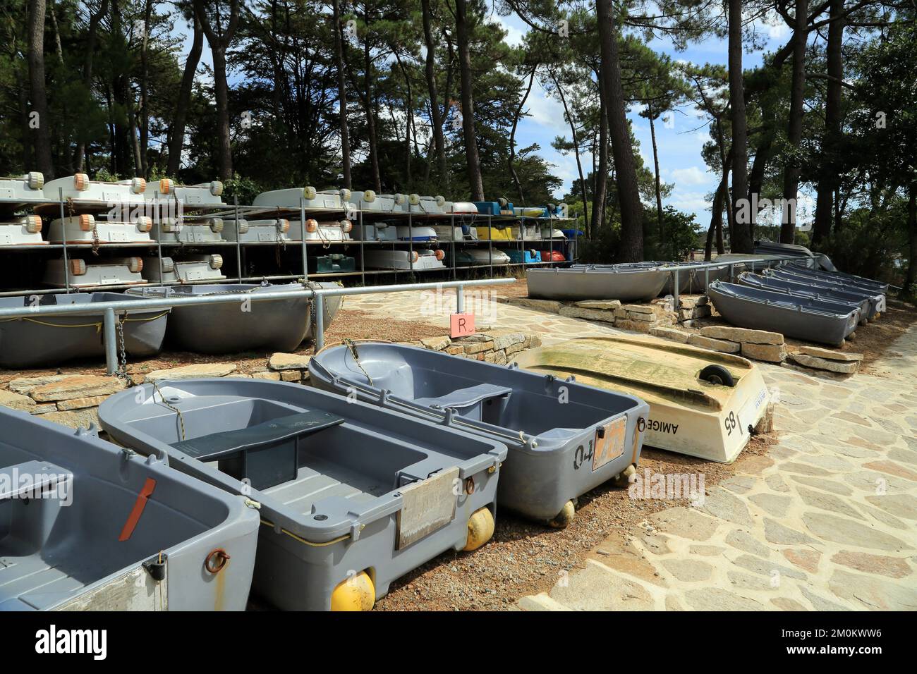 Tourist rowing boats lined up on the shore of the Vincin River at Le ...
