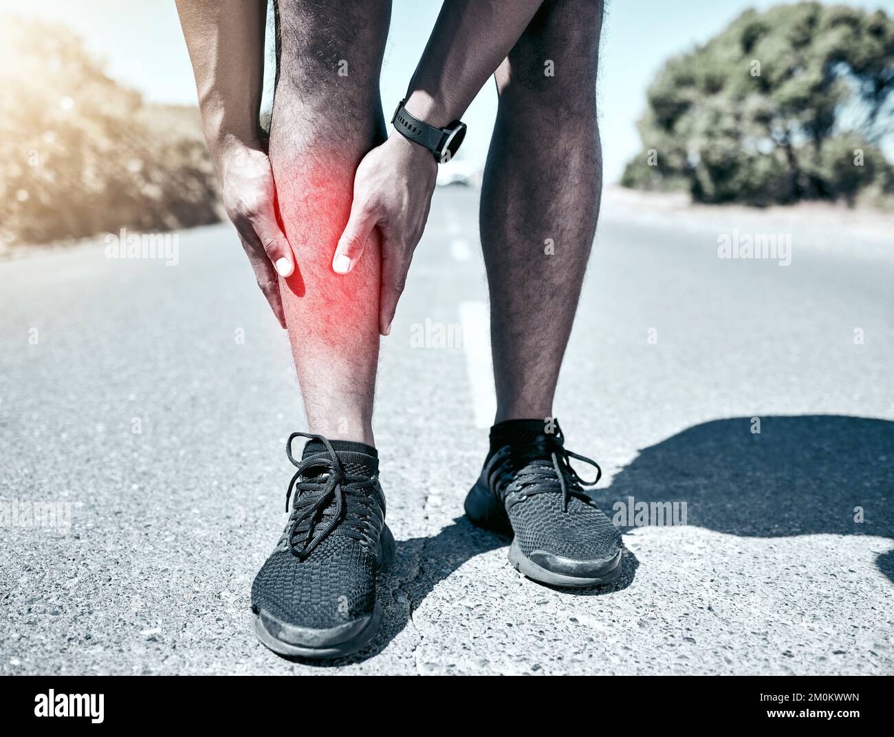Closeup fit mixed race man holding his leg in pain while exercising ...