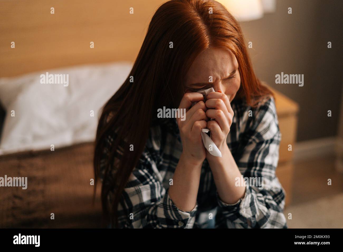 Medium shot portrait of unhappy depressed redhead woman crying and ...
