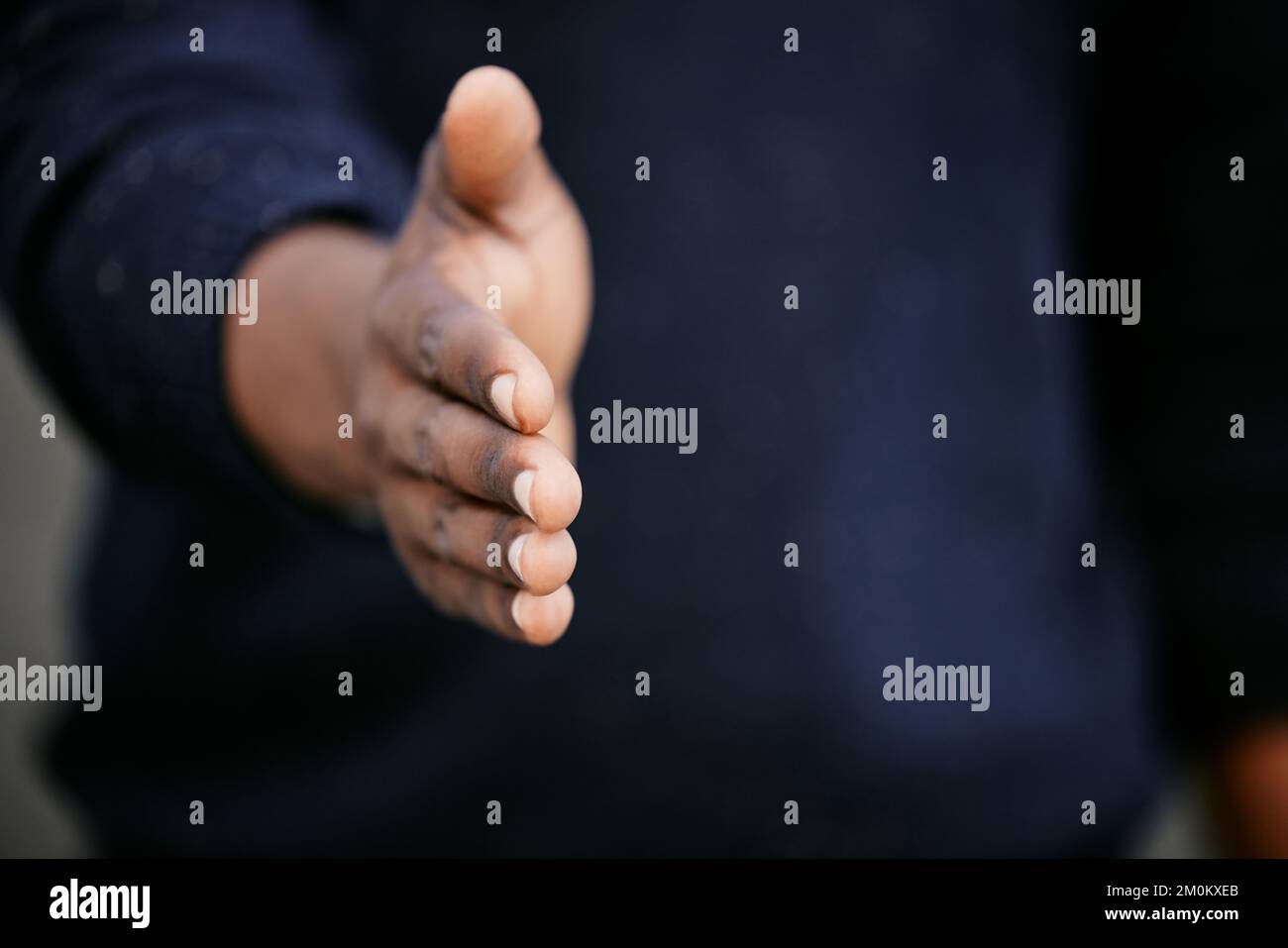 Closeup of an unknown businessman holding his hand out for a handshake ...