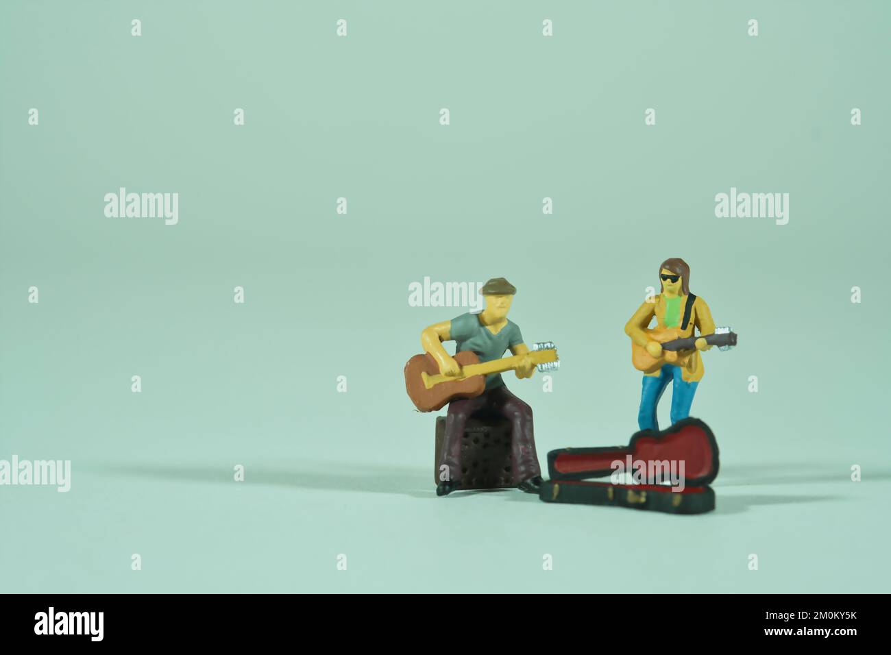 Street musician with guitar making music, miniature figures scene ...