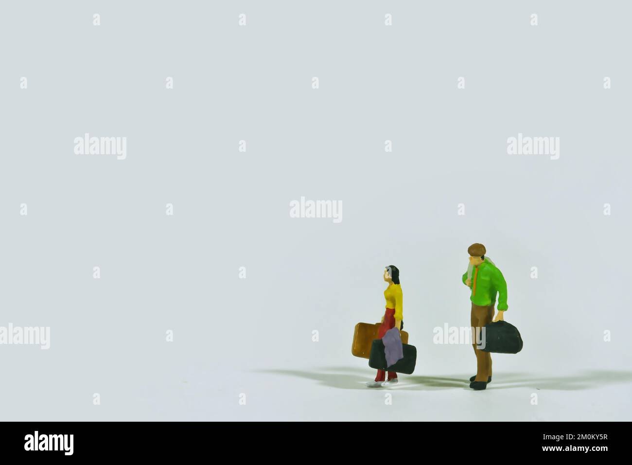 Traveling people with luggage, white background, miniature figures ...