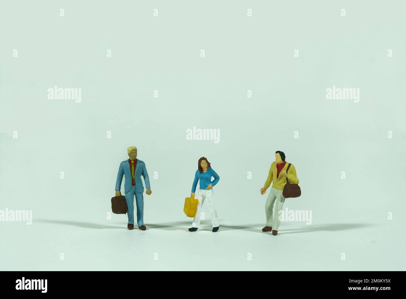 Traveling people with luggage, white background, miniature figures ...