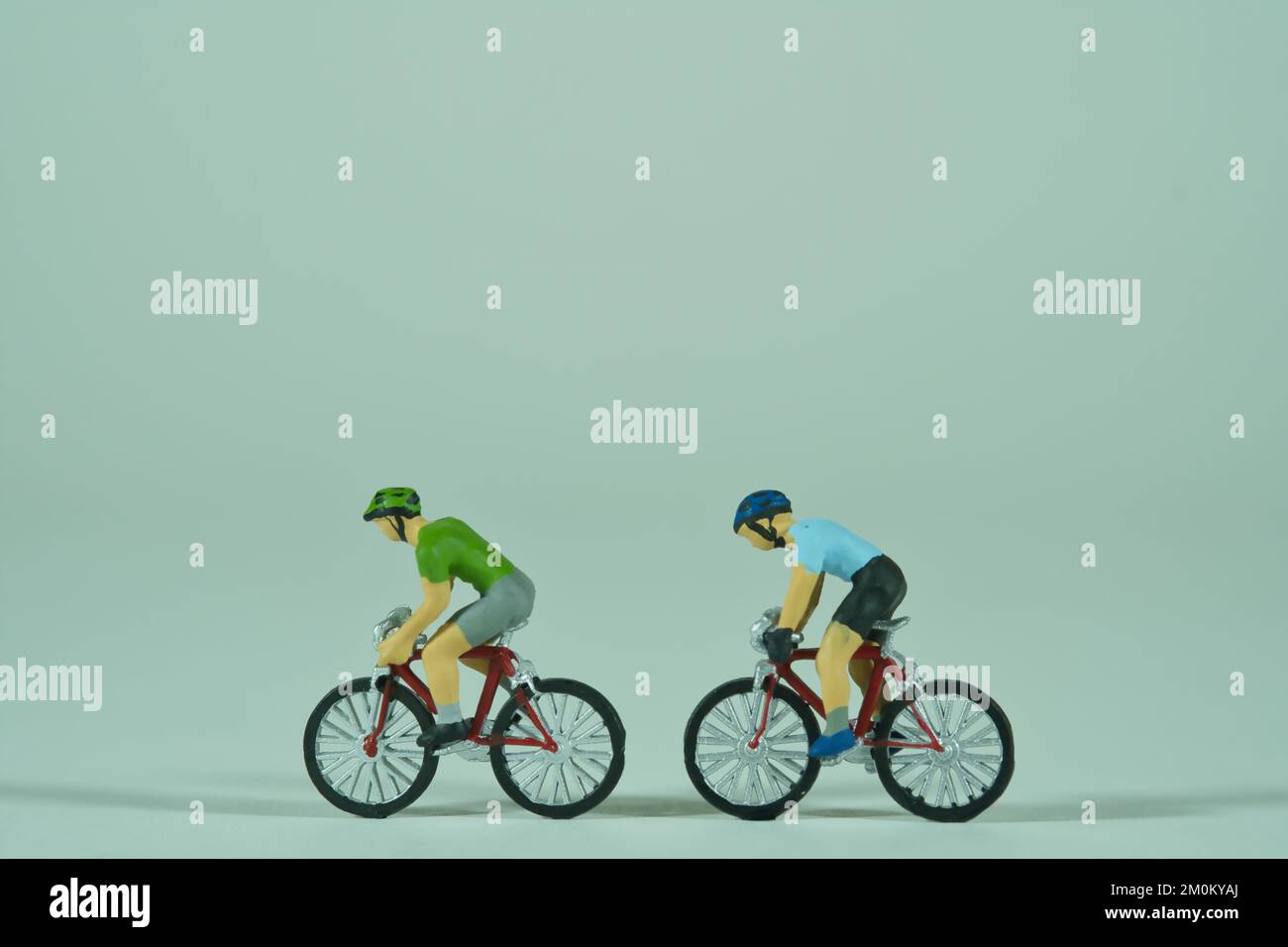 Racing cyclist isolated on light background, view from the side ...