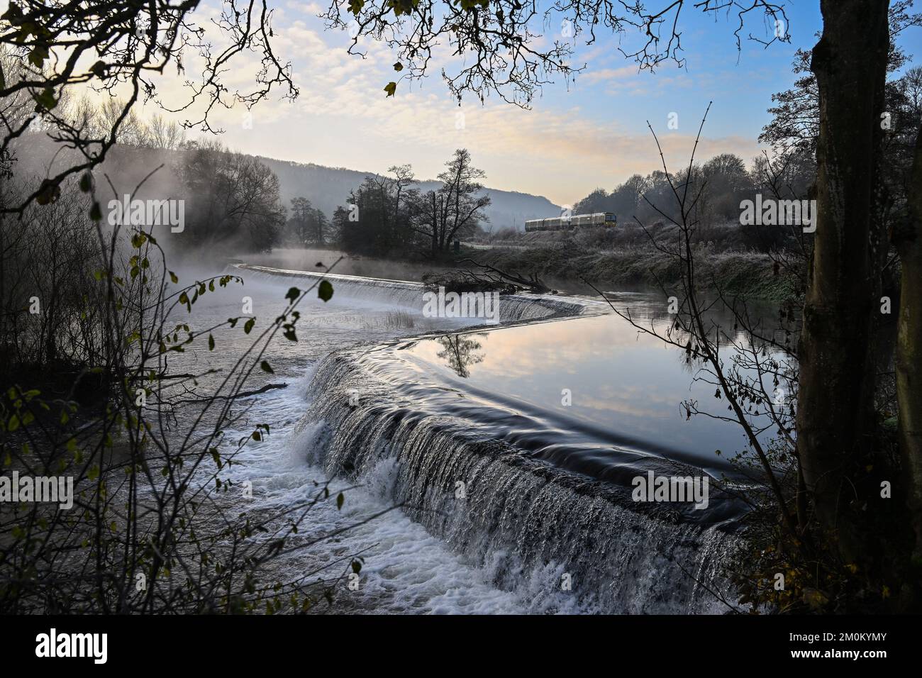 Steam rises off the River Avon at Warleigh Weir near Bath in Somerset ...