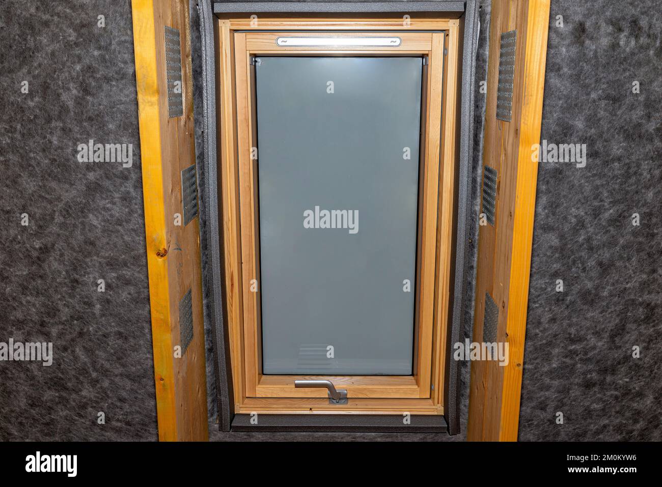 A closed roof hatch in the attic for a chimney sweep, a simple wooden ...