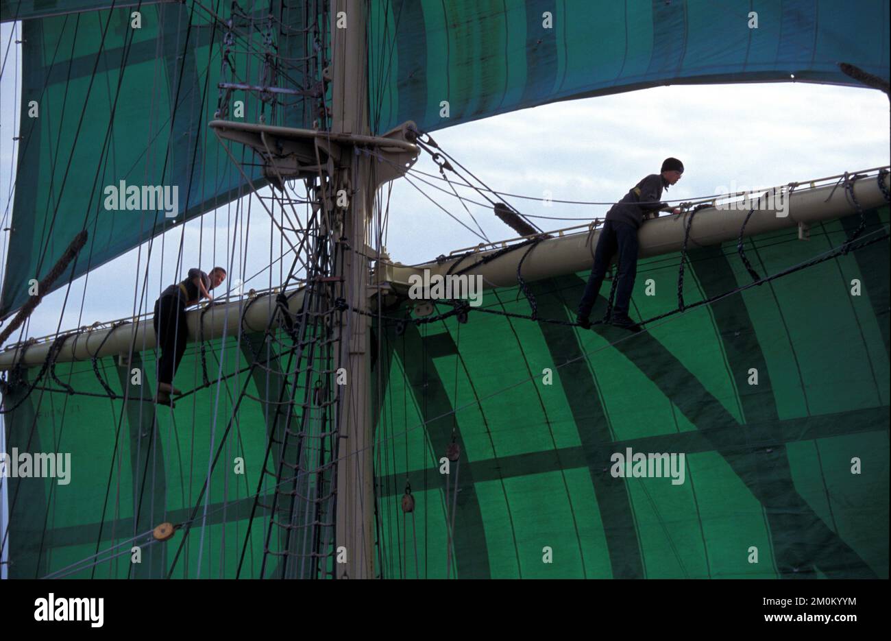 Crew working aloft on the yard of the German tall ship Alexander von ...