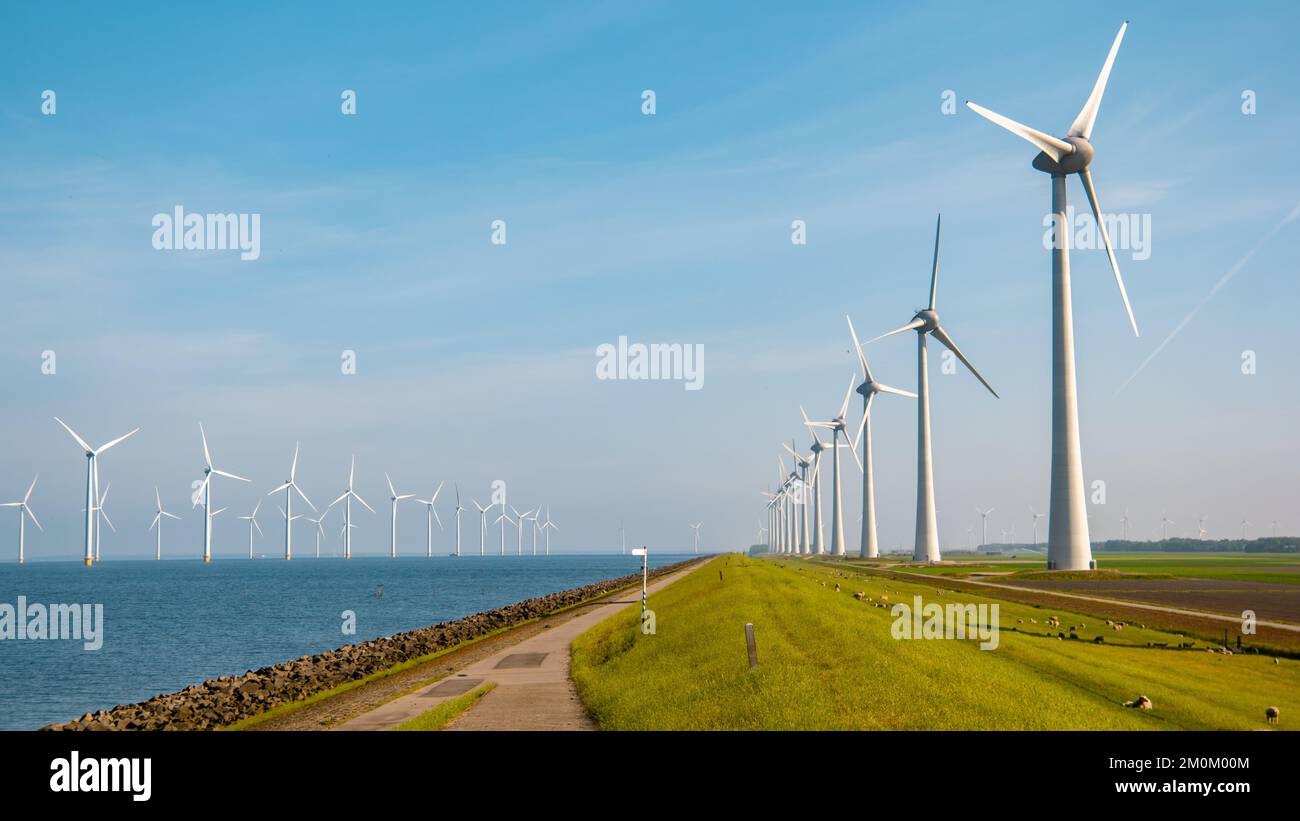 Wind mill park with Windmill turbines generating electric with a blue ...