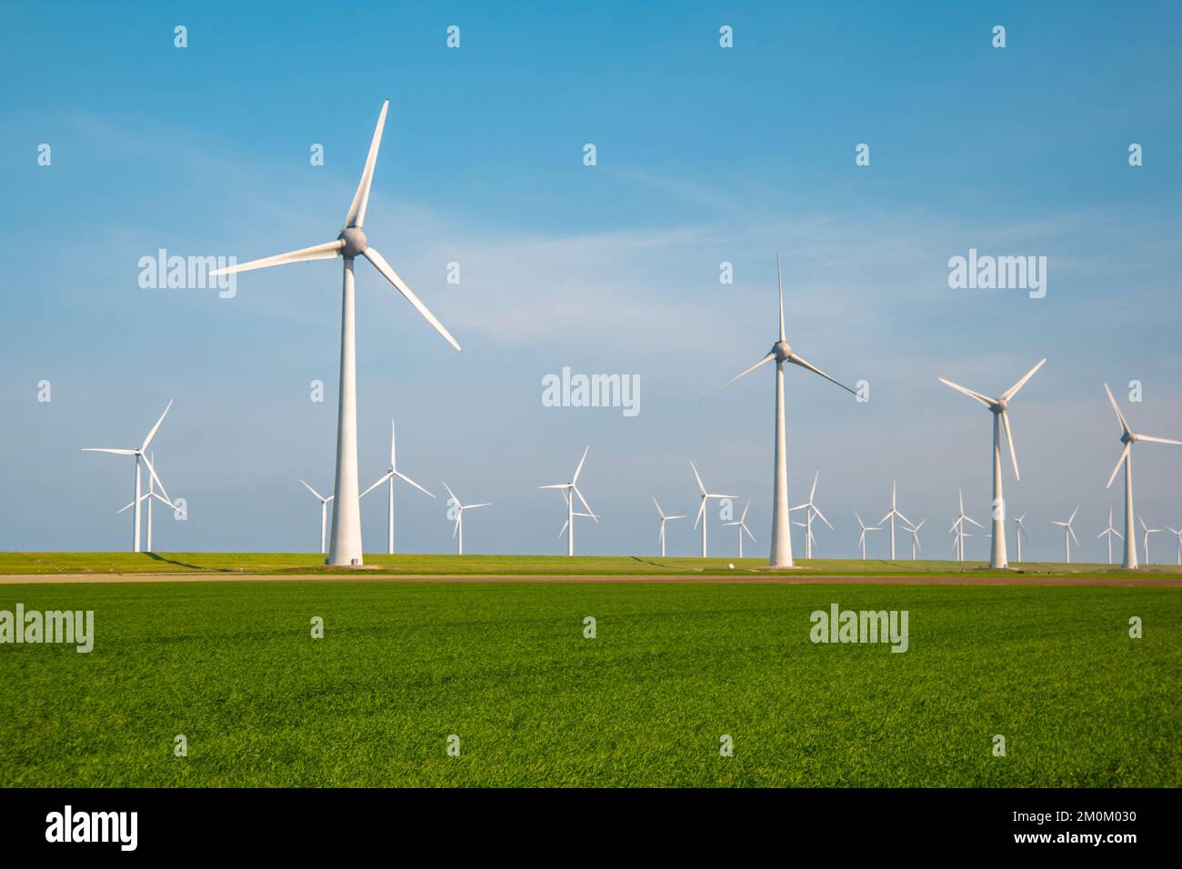 Wind mill park with Windmill turbines generating electric with a blue ...