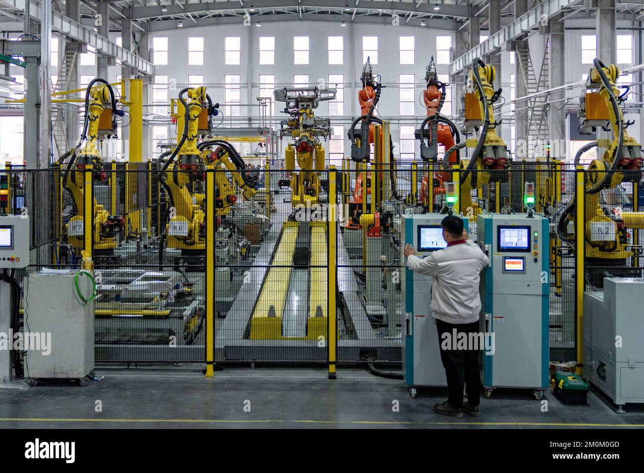 HEFEI, CHIAN - DECEMBER7, 2022 - A worker works in front of automatic ...