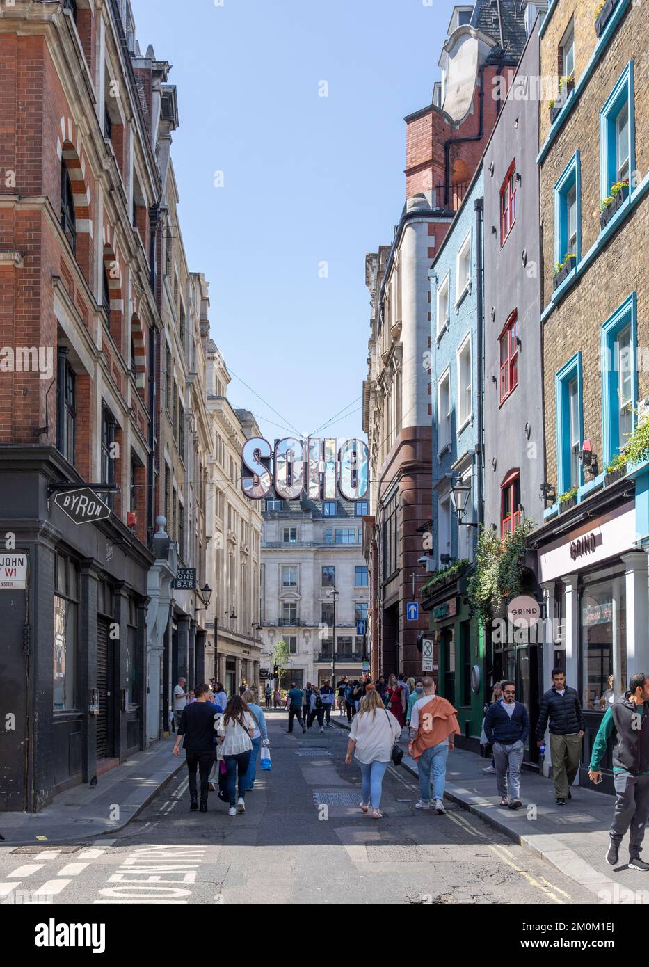 A vertical of a Soho sign across the crowded Beak street in London, UK ...