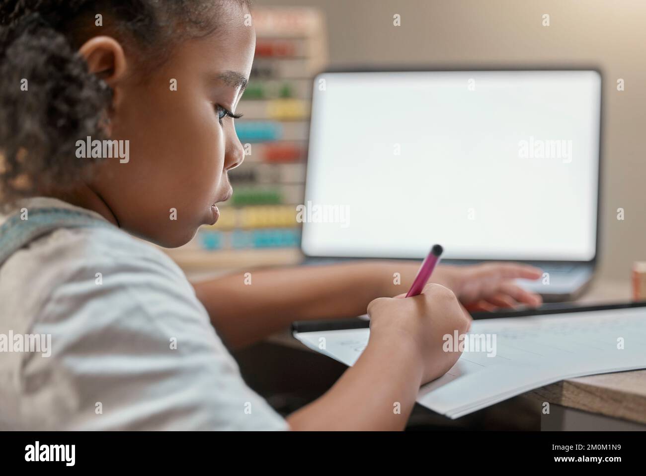 Home, elearning and little girl writing on paper with mockup screen on ...