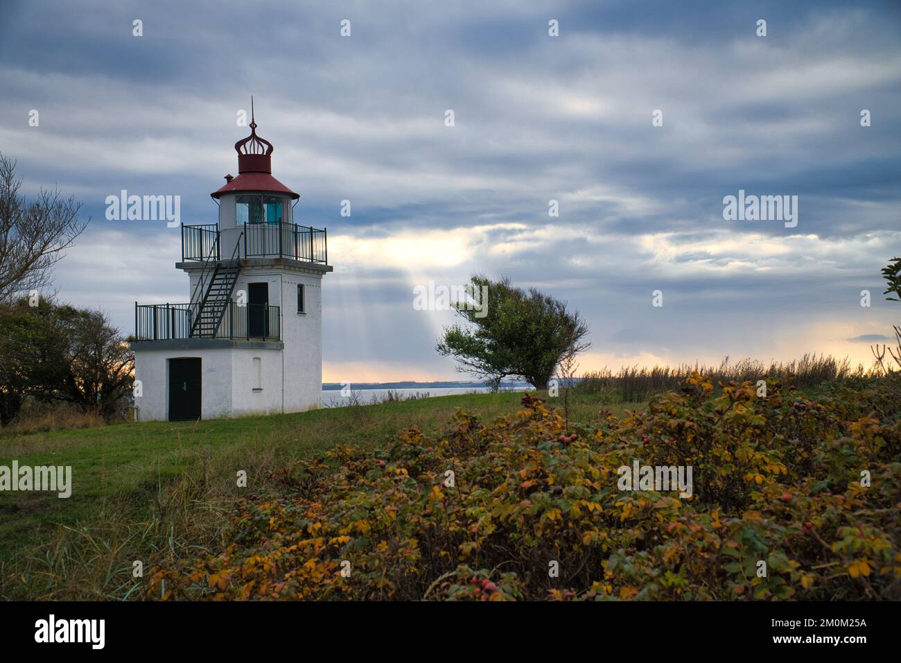 Lighthouse, Spodsbjerg Fyr in Huntsted on the coast of Denmark. Sun ...