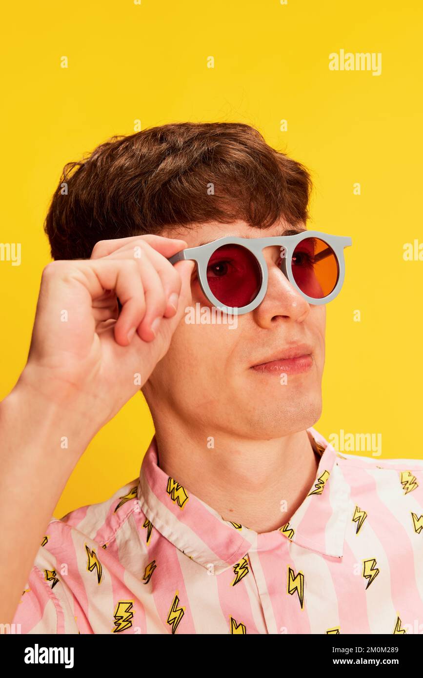 Closeup portrait of astonished young man in fashionable eyewear smiling ...