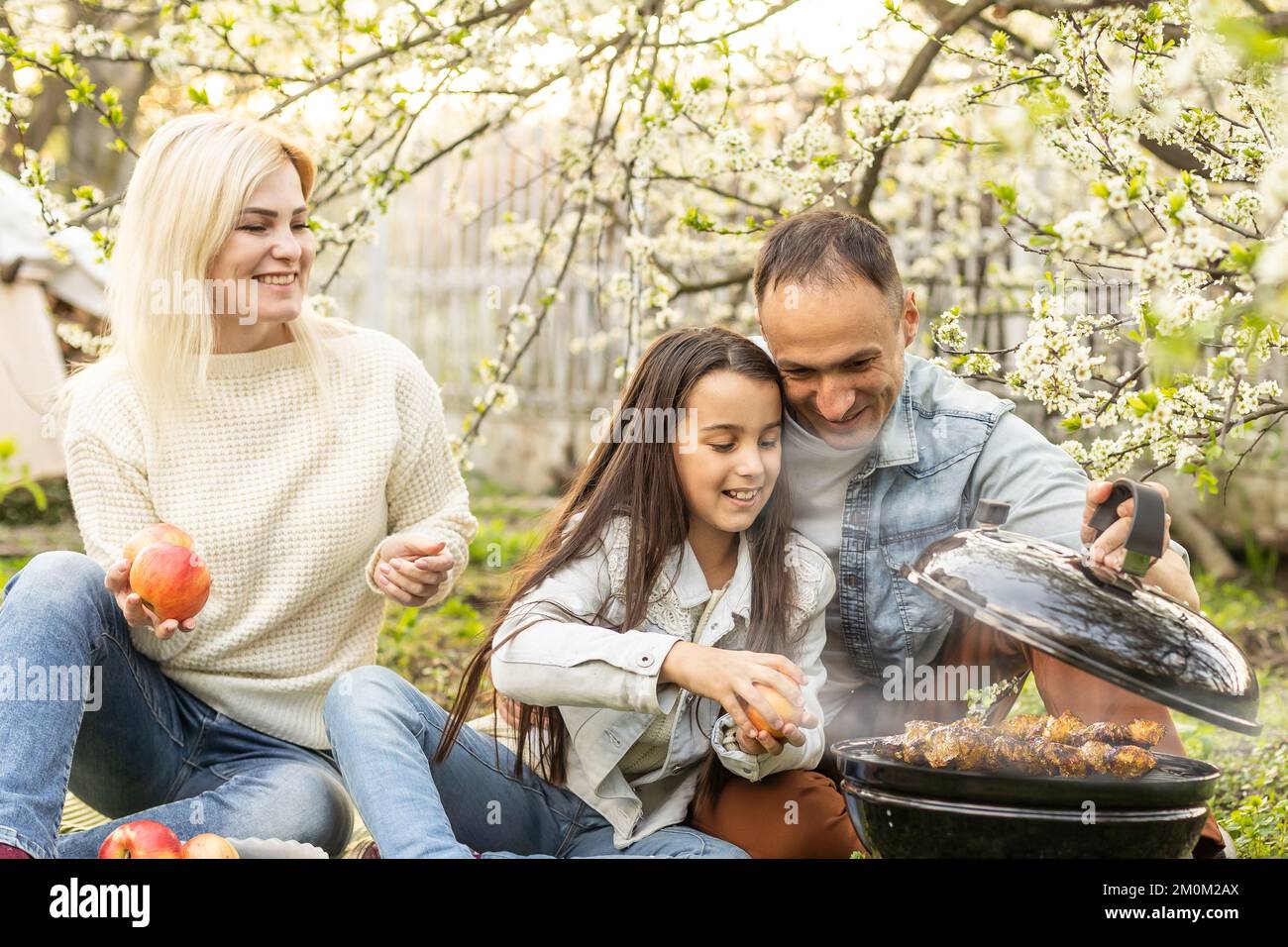 Happy family having barbecue with modern grill outdoors Stock Photo - Alamy