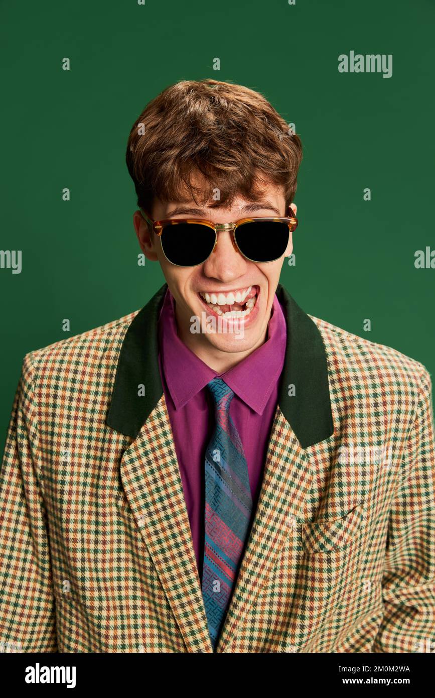 Studio footage young man in vintage fashion style costume, suit posing ...