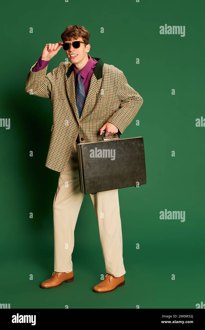Studio footage young man in vintage fashion style costume, suit posing ...