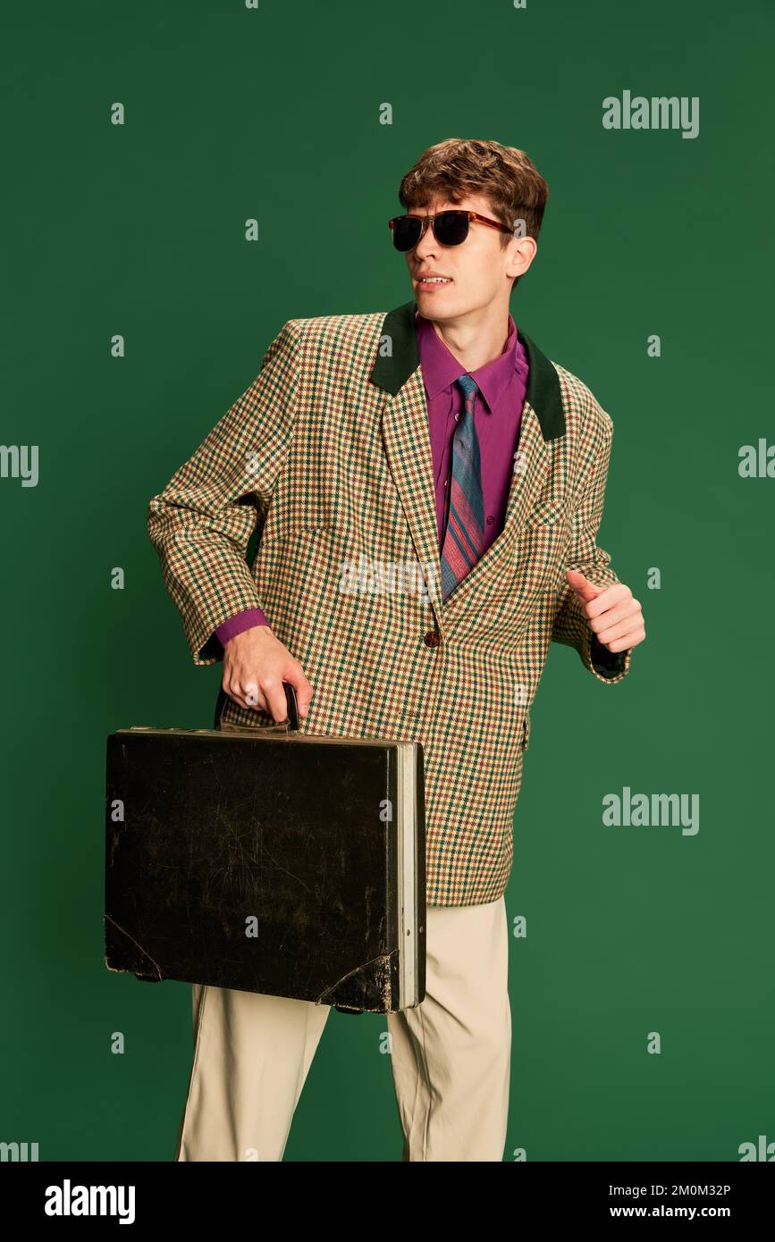 Studio footage young man in vintage fashion style costume, suit posing ...