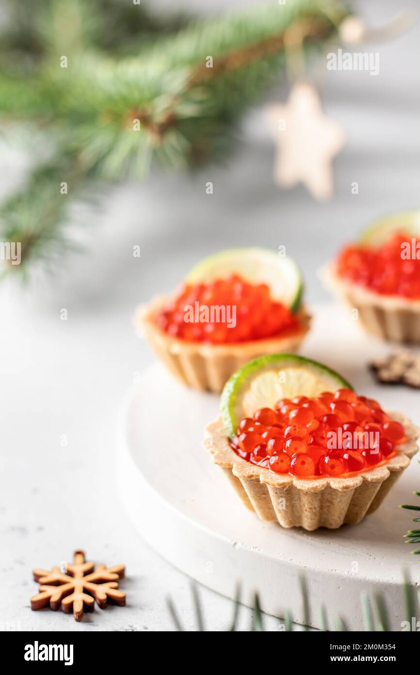 Festive Christmas appetizer tartlets stuffed with red caviar and a ...