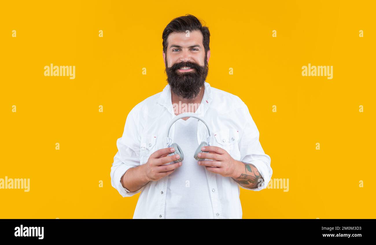 happy man hipster listen ebook in headphones isolated on yellow ...