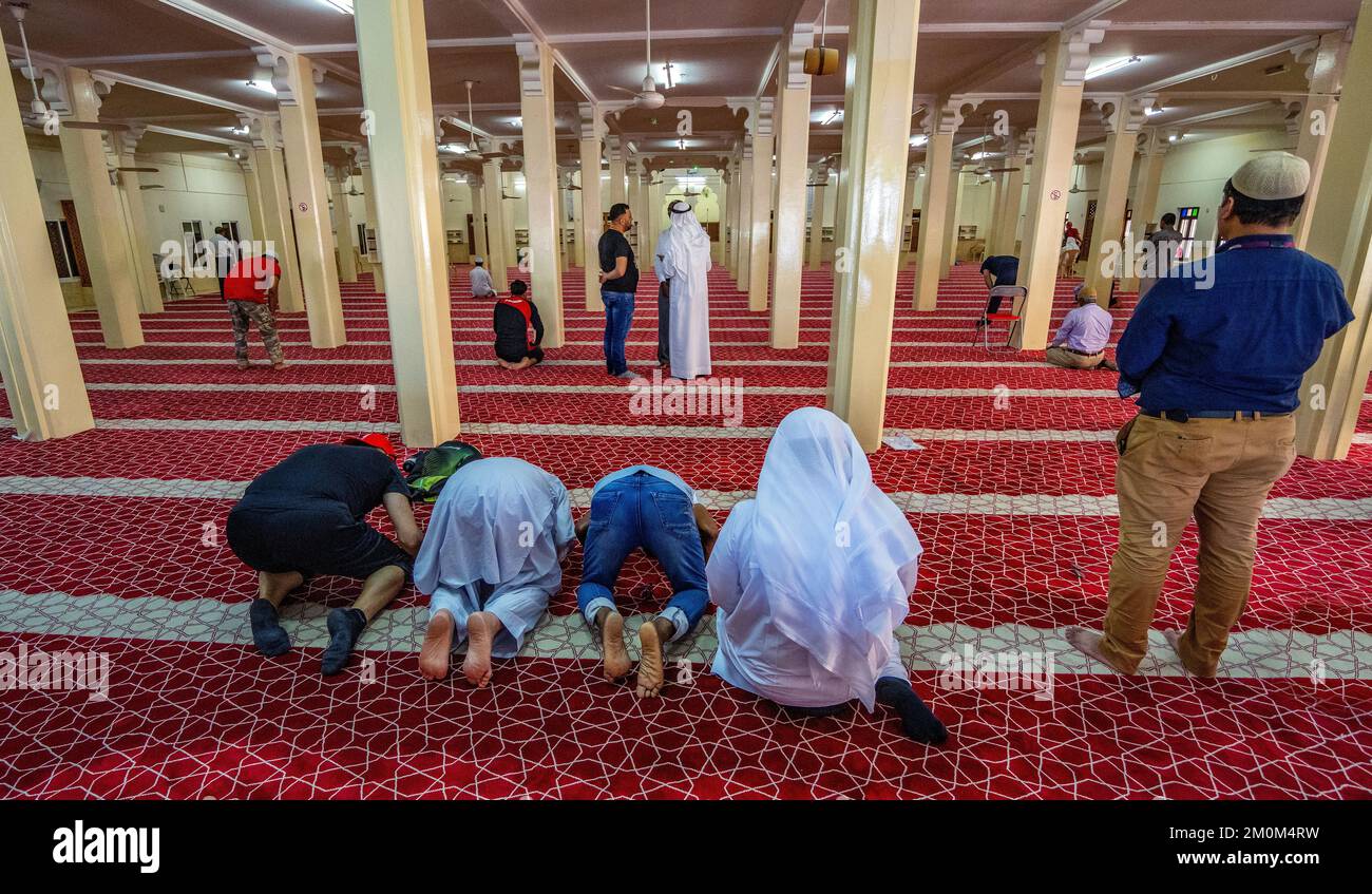 People take part in morning prayers in a mosque in Souq Waqif in Doha ...