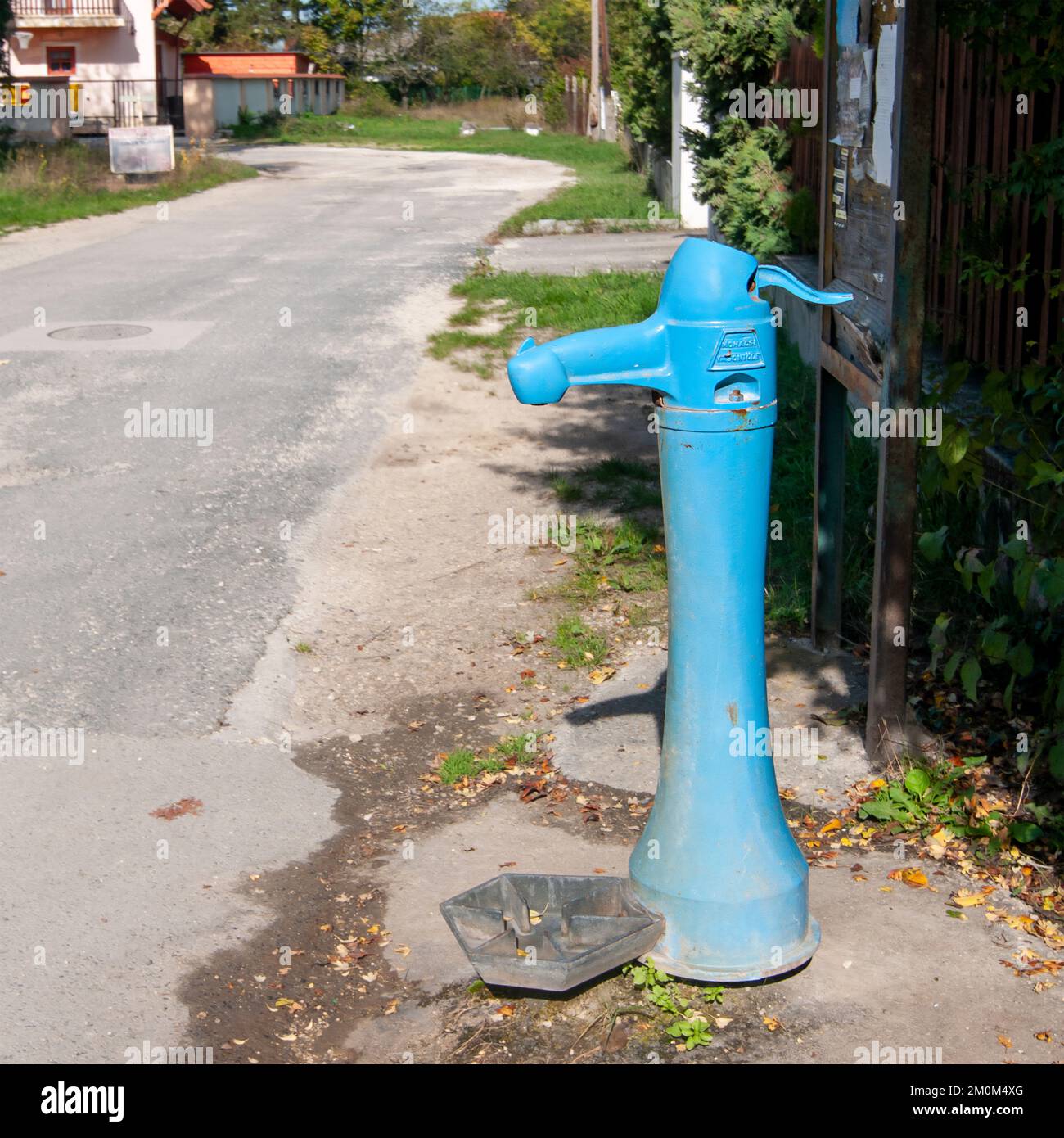 ancient manual water pump painted blue Stock Photo - Alamy