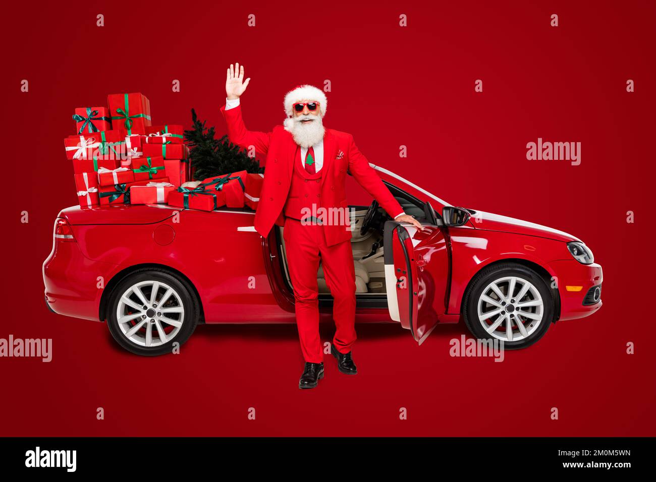 Photo of trendy look santa walk car wave hand greeting audience wear ...